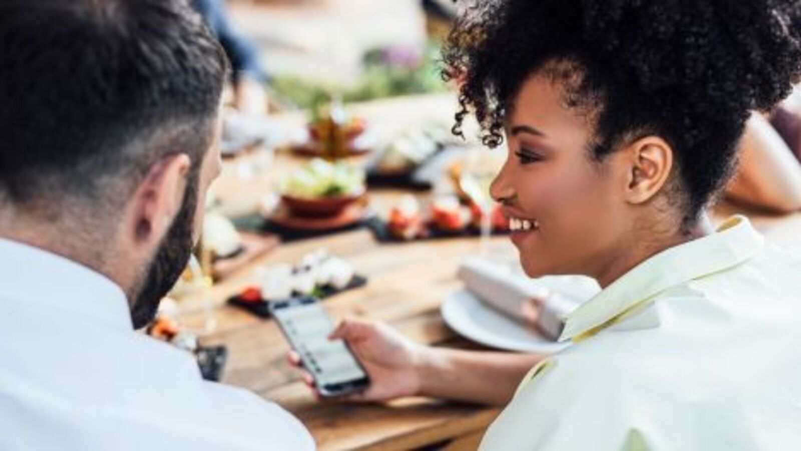 Should restaurants ban cell phones from tables during meals?