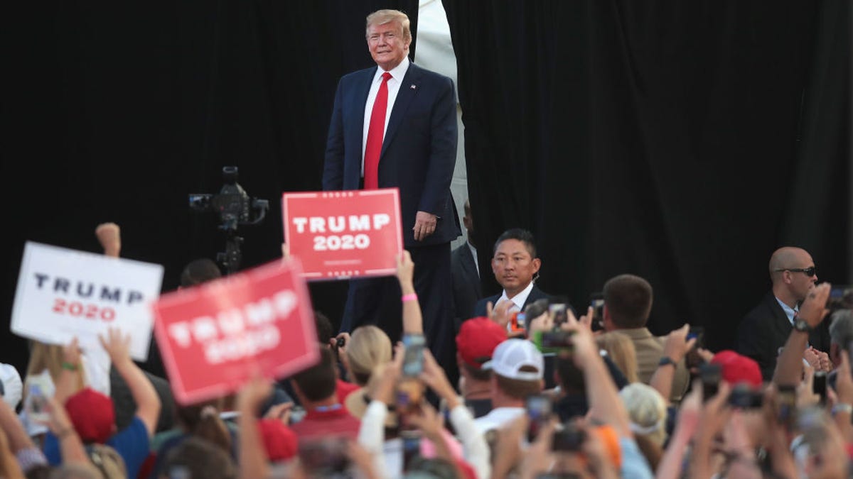 Watch Trump Laugh When Supporter Recommends Shooting Migrants